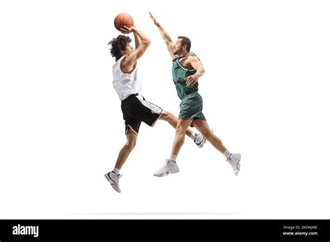 basketball player jumping and performing blocking to another player
