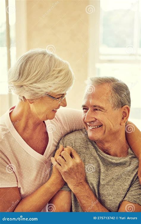 Together Forever A Senior Couple Embracing In Their Bedroom Stock