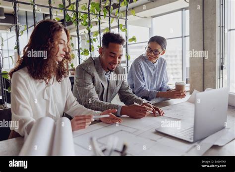Engaging Collaborative Team Meeting Taking Place In A Modern And Innovative Office Space Stock