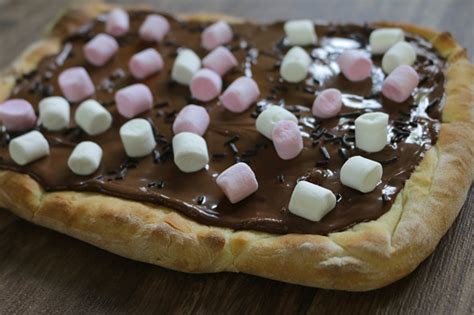 마 시 멜로와 함께 홈메이드 초콜릿 피자 케이크 이미지 뿌리와 슈가 헤이즐넛 스프레드로 채워진 구운 피자 크 러스트와 레드와 화이트 미니 마쉬 멜 로우 핫 초콜릿 과자