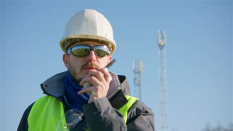 Premium Stock Video Male Engineer Talking Over The Radio With