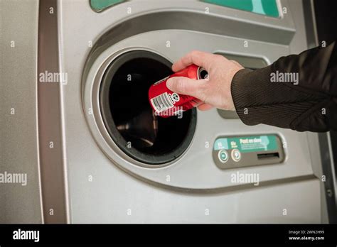 Returning Empty Bottles And Cans In The Recycling Machine At The