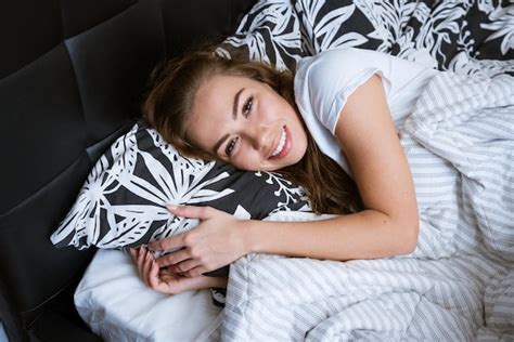 Premium Photo Happy Cute Caucasian Woman Lying On Comfortable Bed