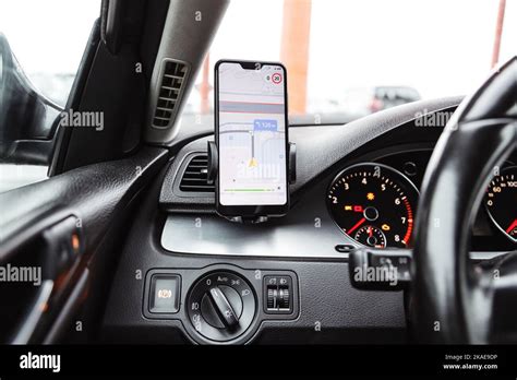 Smartphone With Navigation Route On Screen Mounted On Phone Holder At