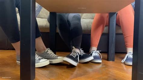 Two Girls Playing Secret Footsie Under The Table Hiding From Jealous