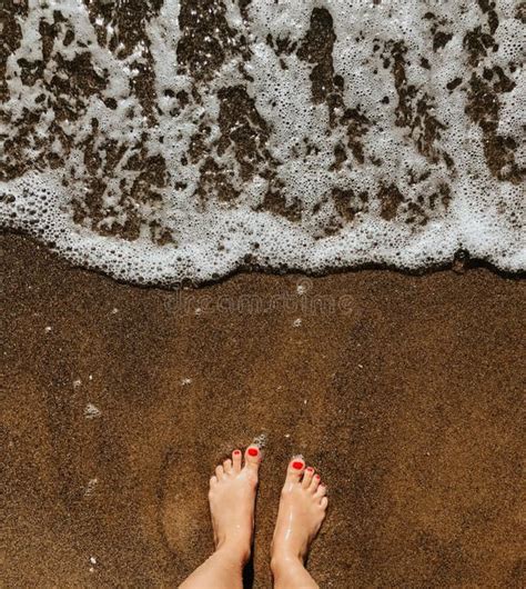 Woman Legs Barefoot At Sea Foam Waves On Sand Beach Summer Day Top