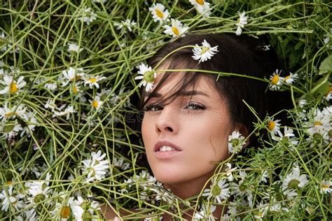 Beautiful Sensual Brunette Woman Lying On A Grass Outdoor Beautiful