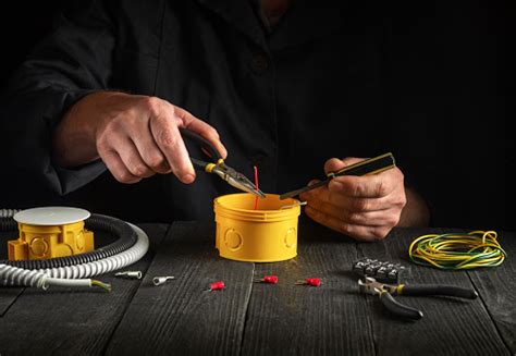 정션 박스에 케이블 또는 와이어 설치 직업적인 주인 전기 기술자의 작업장에 있는 전기 연결 작업 중 전문 마스터 전기 기술자의 손 클로즈업 개체 그룹에 대한 스톡 사진 및