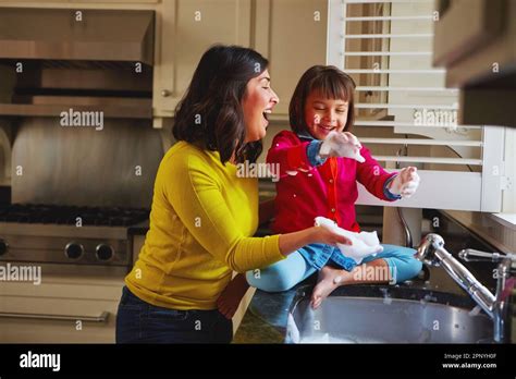 If Youre Not Getting Wet Youre Doing It Wrong A Young Mother And Her Daughter Playing By The