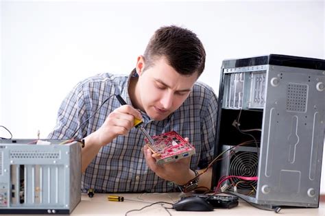 Premium Photo Young Technician Repairing Computer In Workshop