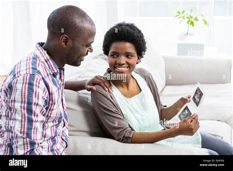 Pregnant Couple Looking At Ultrasound Scan Stock Photo Alamy