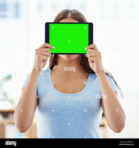 Check out this awesome app. a woman holding a digital tablet with a chroma key screen in front ...