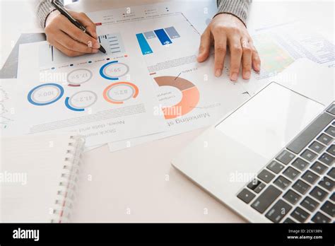 Businesswoman Analyze Document In His Handsgraphs And Diagramm On Notebook Screenfinancial And