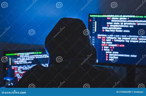 Computer Hacker Silhouette Of Hooded Man Using Laptop And Monitor For Steal Data Cyber Crime
