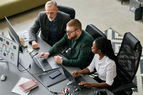 team discussing software development project in office stock image