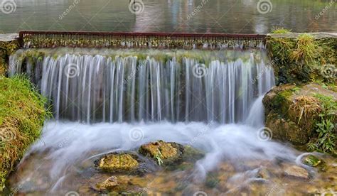 Metallic Grating Cascade Regulating Creek Water Flow Stock Image