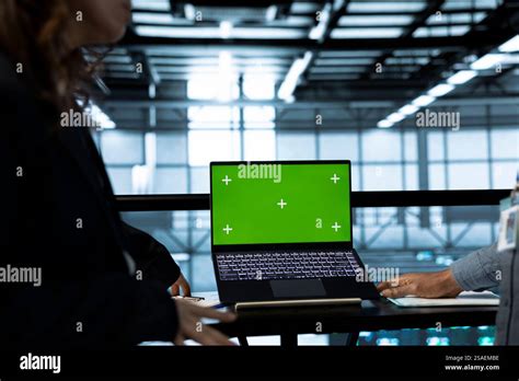 computer scientists in data center using isolated screen mockup laptop