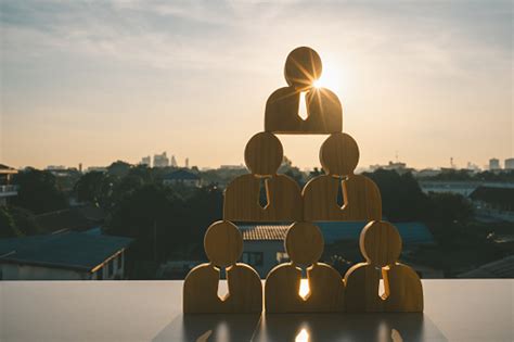 성공한 사업가가 위에 있는 피라미드 모양으로 서 있는 사업가 모델 비즈니스의 개념은 팀워크를 필요로 하며 조직에서 중요한 사람들은 보스와 리더입니다 3차원 형태에 대한 스톡