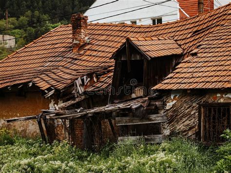 Collapsing Wooden House With A Broken Roof And Crumbling Walls An