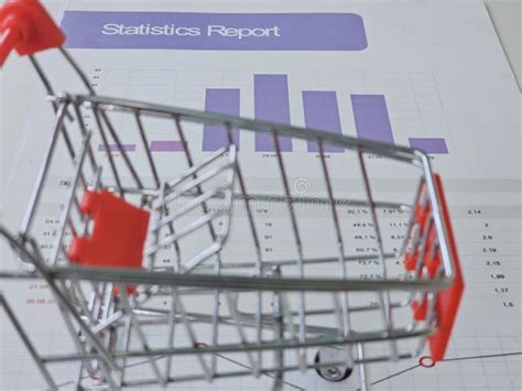 Shopping Cart Placed On A Statistics Report With Graphs And Data