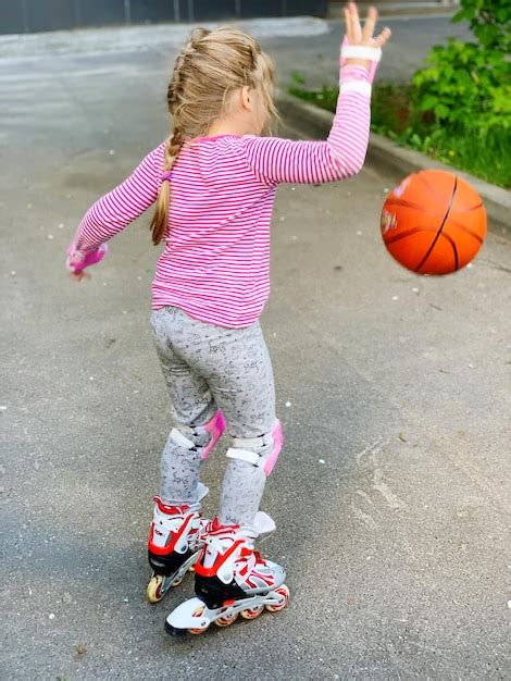 Premium Photo Rear View Of Girl Playing With Ball On Road