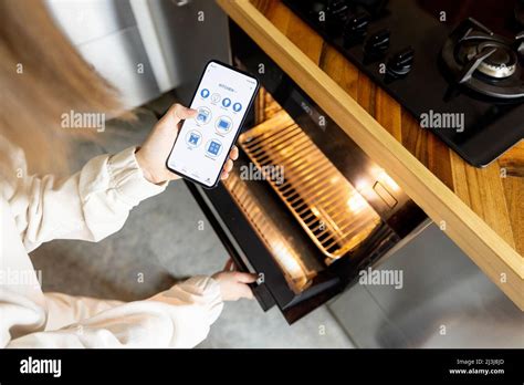 Controlling Kitchen Appliances With A Smart Phone Stock Photo Alamy