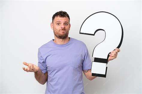 Premium Photo Young Brazilian Man Isolated On White Background Holding A Question Mark Icon