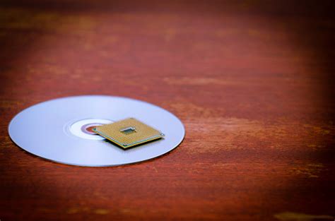 A Square Computer Processor Pulled From A Broken Computer The Processor Lies On A Compact Disc