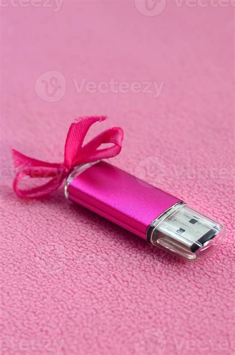 Brilliant Pink Usb Flash Memory Card With A Pink Bow Lies On A Blanket Of Soft And Furry Light