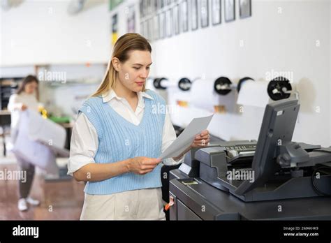 Technician Operator Calibrating Plotter Machine Typing On Computer
