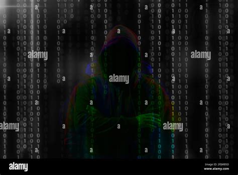 Silhouette Of Anonymous Hacker And Digital Binary Code On Dark