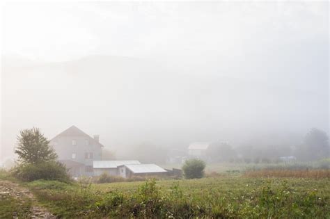 Premium Photo Mountain From View With Small Village And Flow Fog