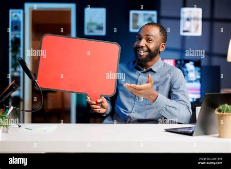 happy man filming sponsored content holding empty copy space sign in
