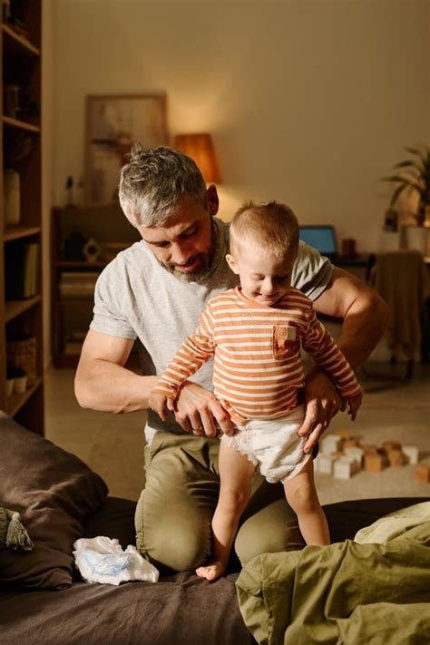 Father Putting Clean Nappy On Baby Son Stock Photo Image Of Hygiene