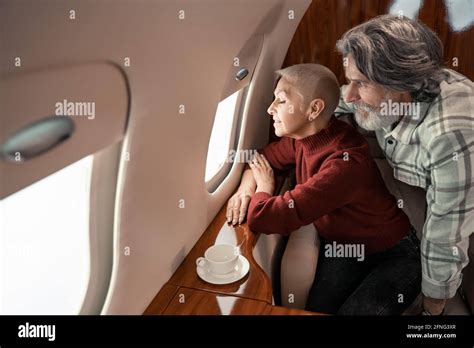 Mature Man Hugging Smiling Wife Near Window Of Plane Stock Photo Alamy