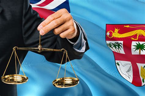 Fijian Judge Is Holding Golden Scales Of Justice With Fiji Waving Flag