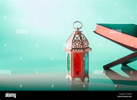 Arabic lamp with beautiful light and holy koran. Islamic concept image ...