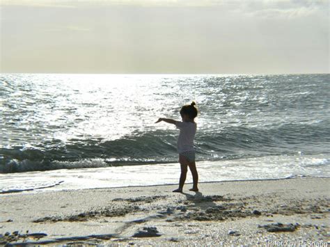 Premium Photo Rear View Of Girl Standing On Shore At Beach