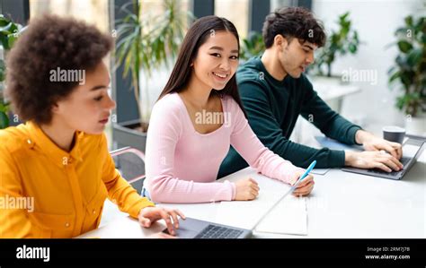 Study Process Diverse Classmates Sitting At Desk Asian Lady Smiling