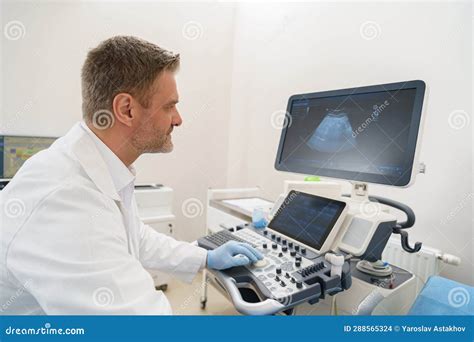 Confident Concentrated Sonographer Looking At The Screen During The