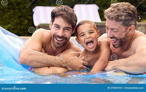 Same Sex Family With Two Dads And Son On Holiday In Swimming Pool Together Stock Image Image