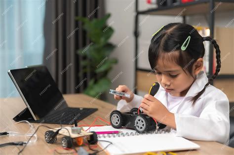 Premium Photo Asian Littlle Girl Constructing And Coding Robot At Stem Classfixing And Repair