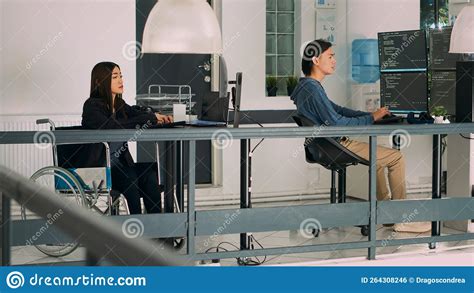 Database Programer With Physical Disability Writing Code On Computer
