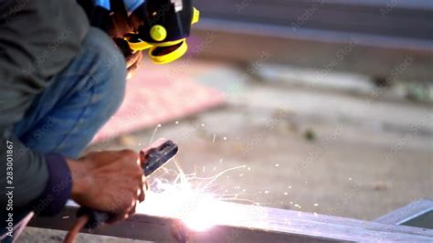Hd Slow Motion Close Up Shot Of Construction Worker Welder Wearing Welding Mask Using Electric