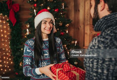 기쁜 성 탄과 새 해 복 많이 받으세요입니다 젊은 커플 집에서 휴일을 축 하 행복 한 젊은 남자와 여 자가 서로 게 선물을 주는