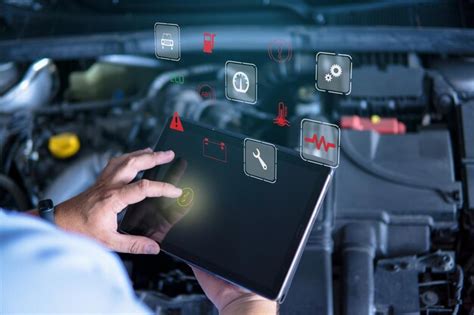 Premium Photo | Auto mechanic with digital tablet at work making an engine repair diagnosis of a ...