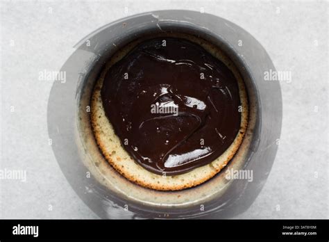 Overhead View Of Layered Cake Being Filled With Chocolate Ganache Top