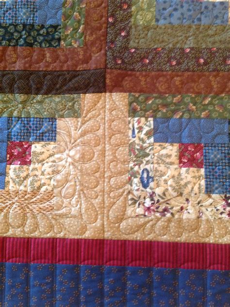 Log Cabin Lap Quilt With Feather Blocks And Log Borders