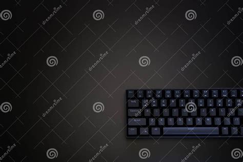 fragment of a black game wireless computer keyboard on a dark