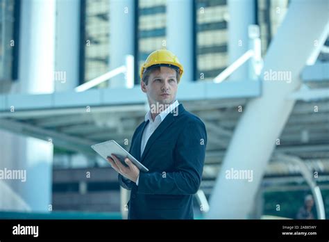 Portrait Of Multiethnic Architect With Blueprints And Business